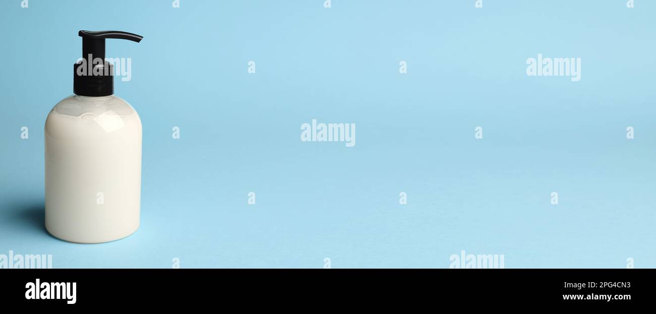 Bottle of liquid soap on light blue background, space for text. Banner ...