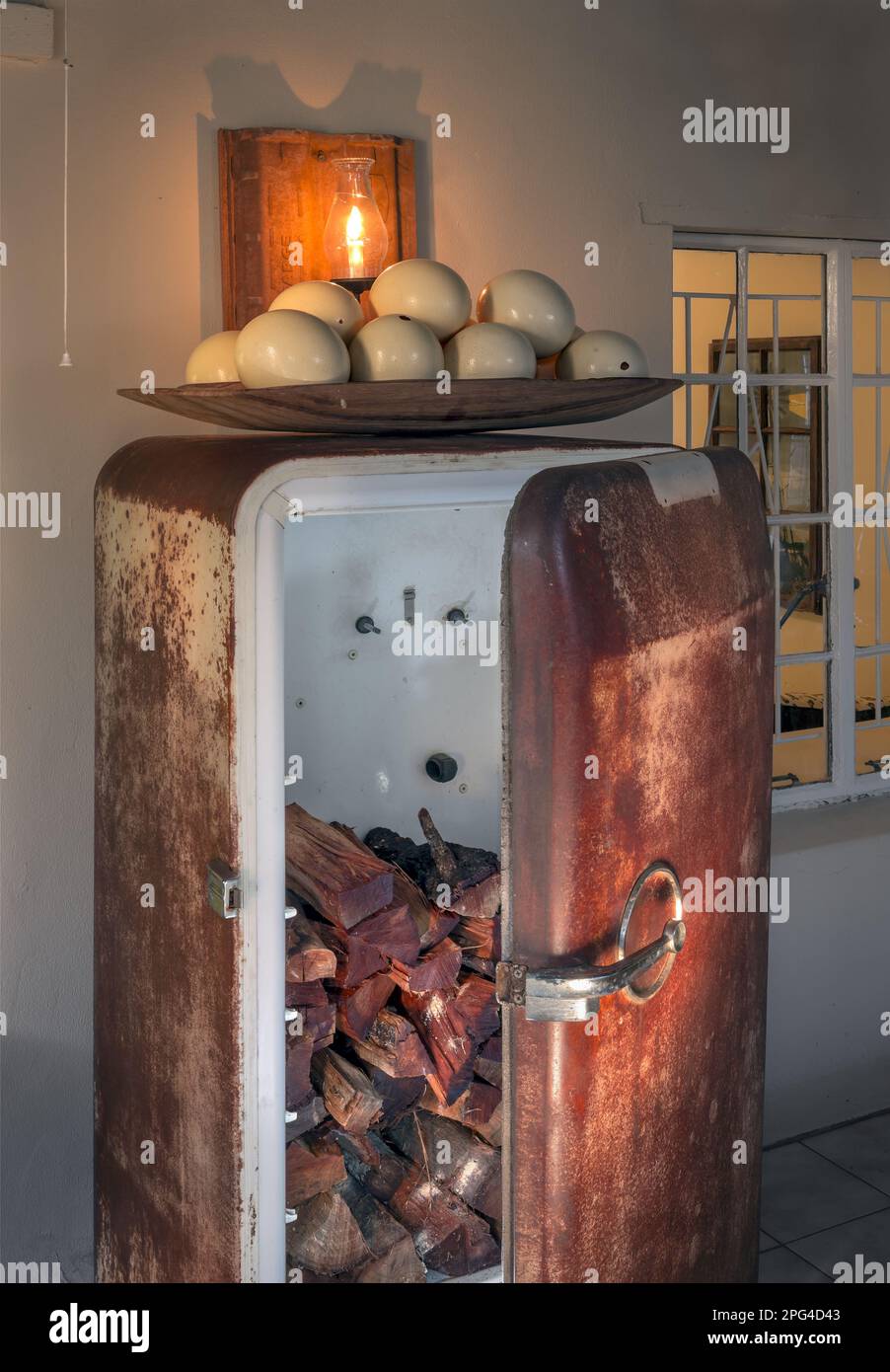 An old fridge acts as fire wood storage place in 'Die Plaashuis' Guest ...