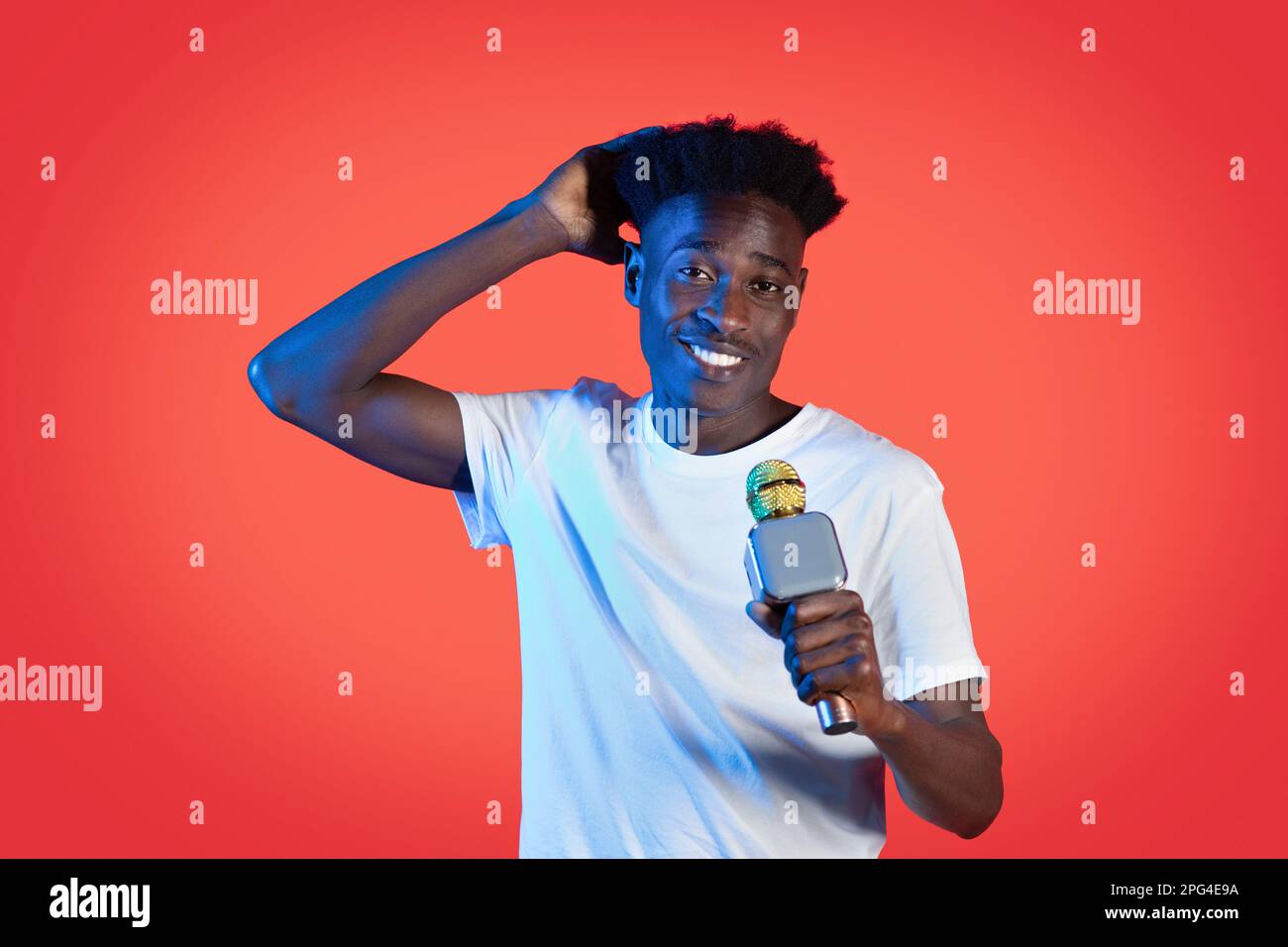 Cool young black guy with microphone singing or performing Stock Photo ...