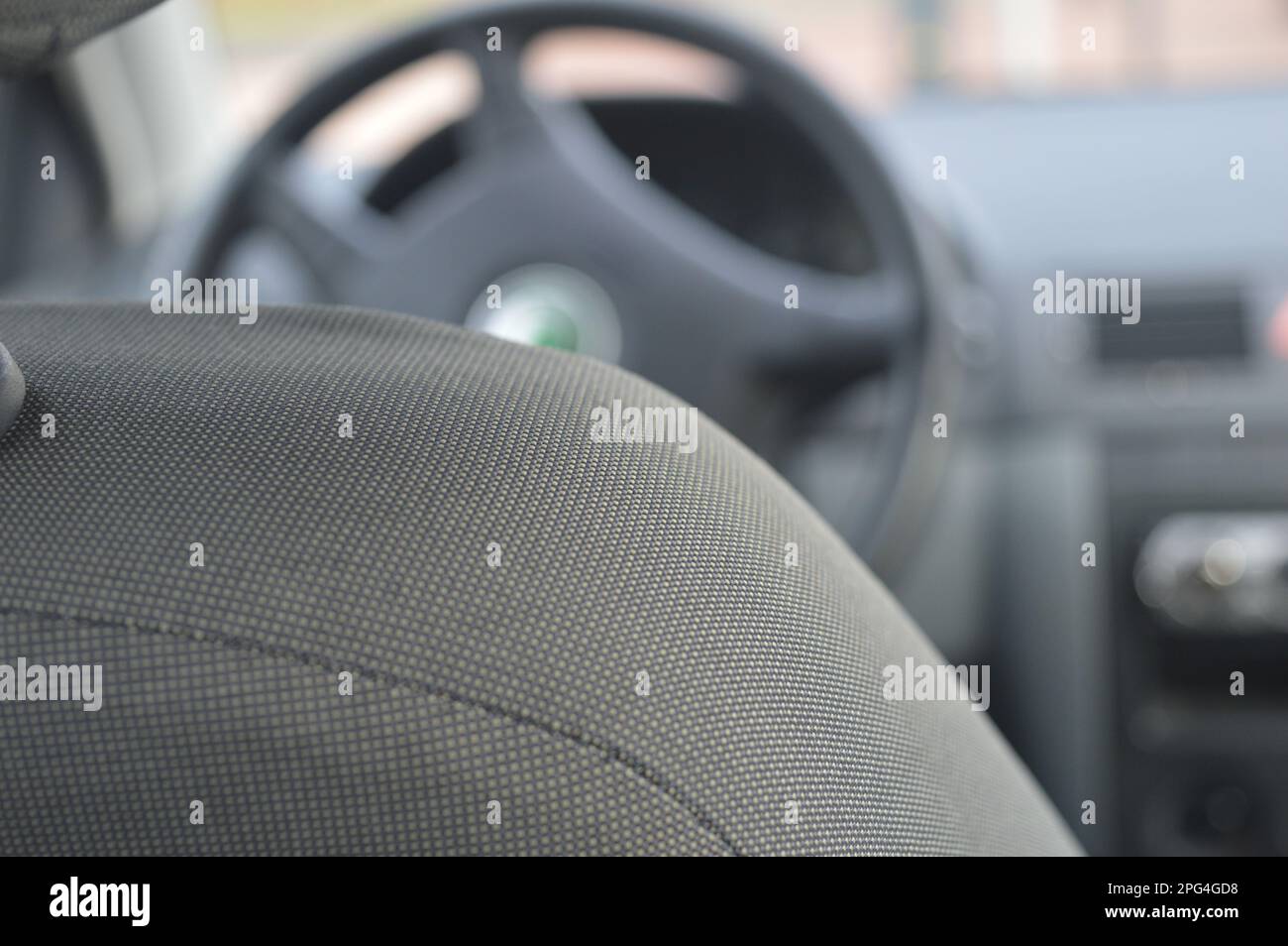 the view from the back seat of a car showing the steering wheel and ...