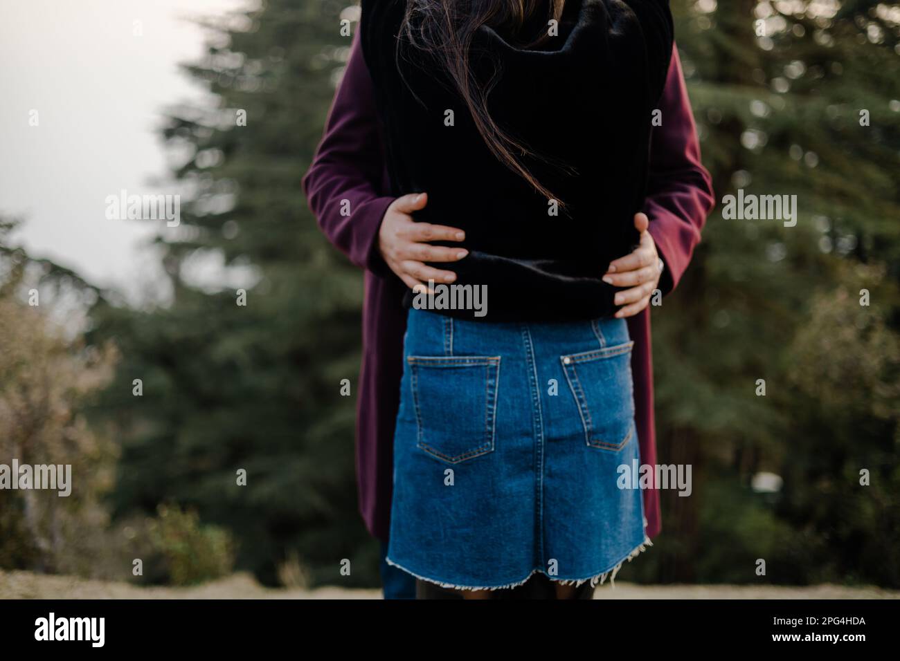 A young couple hugging in a lush outdoor environment Stock Photo - Alamy