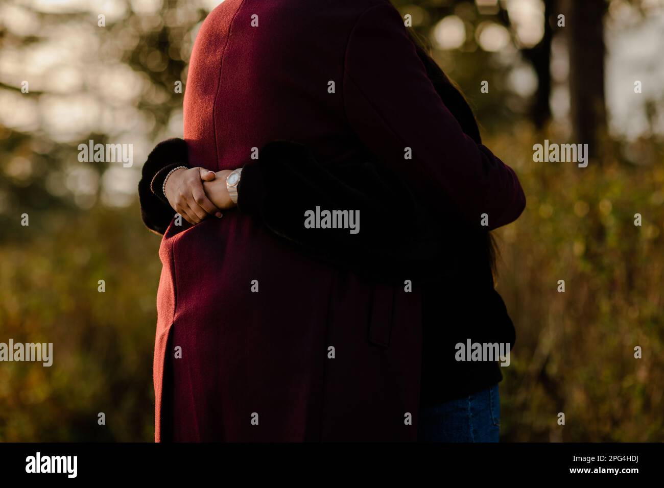 A young couple hugging in a lush outdoor environment Stock Photo - Alamy