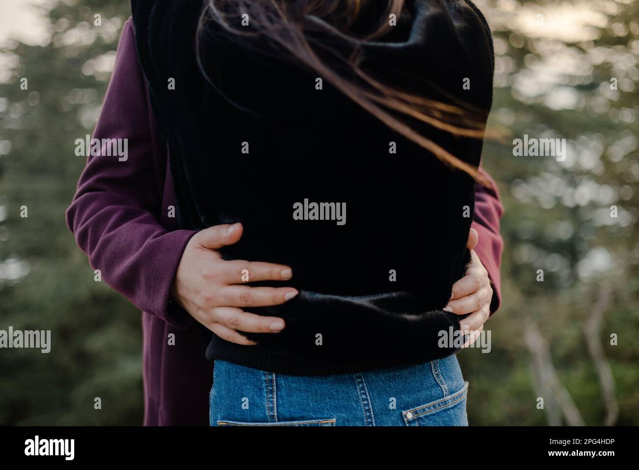 A young couple hugging in a lush outdoor environment Stock Photo - Alamy
