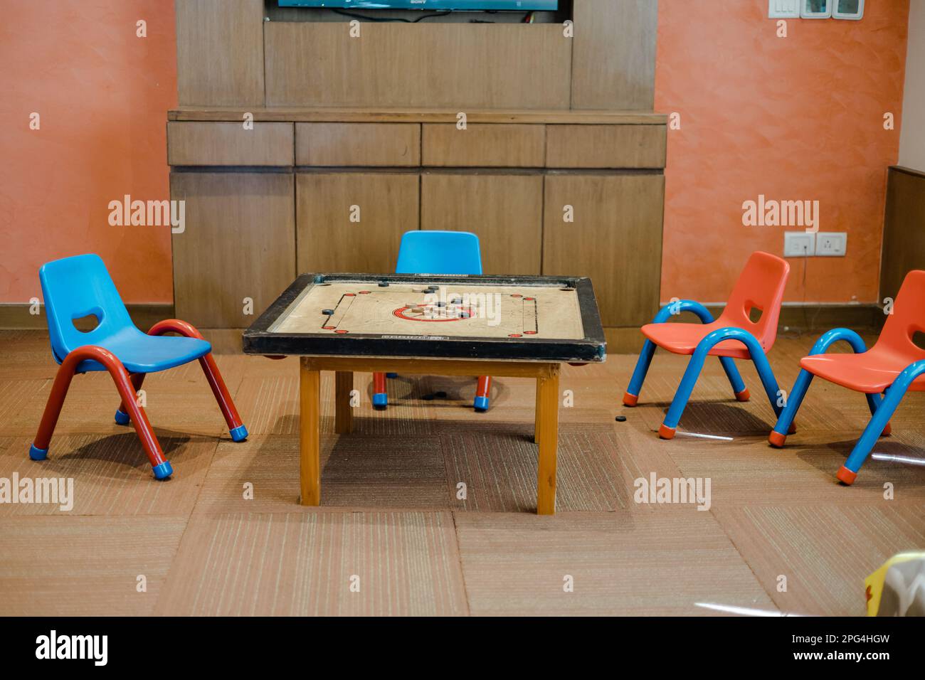 A brightly lit room with a colorful children's table and chairs set ...
