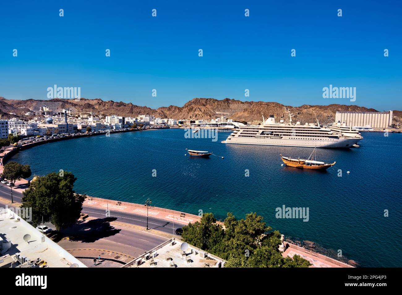 Cruise ship and traditional dhows in the Mutrah Harbor, Muscat, Oman ...
