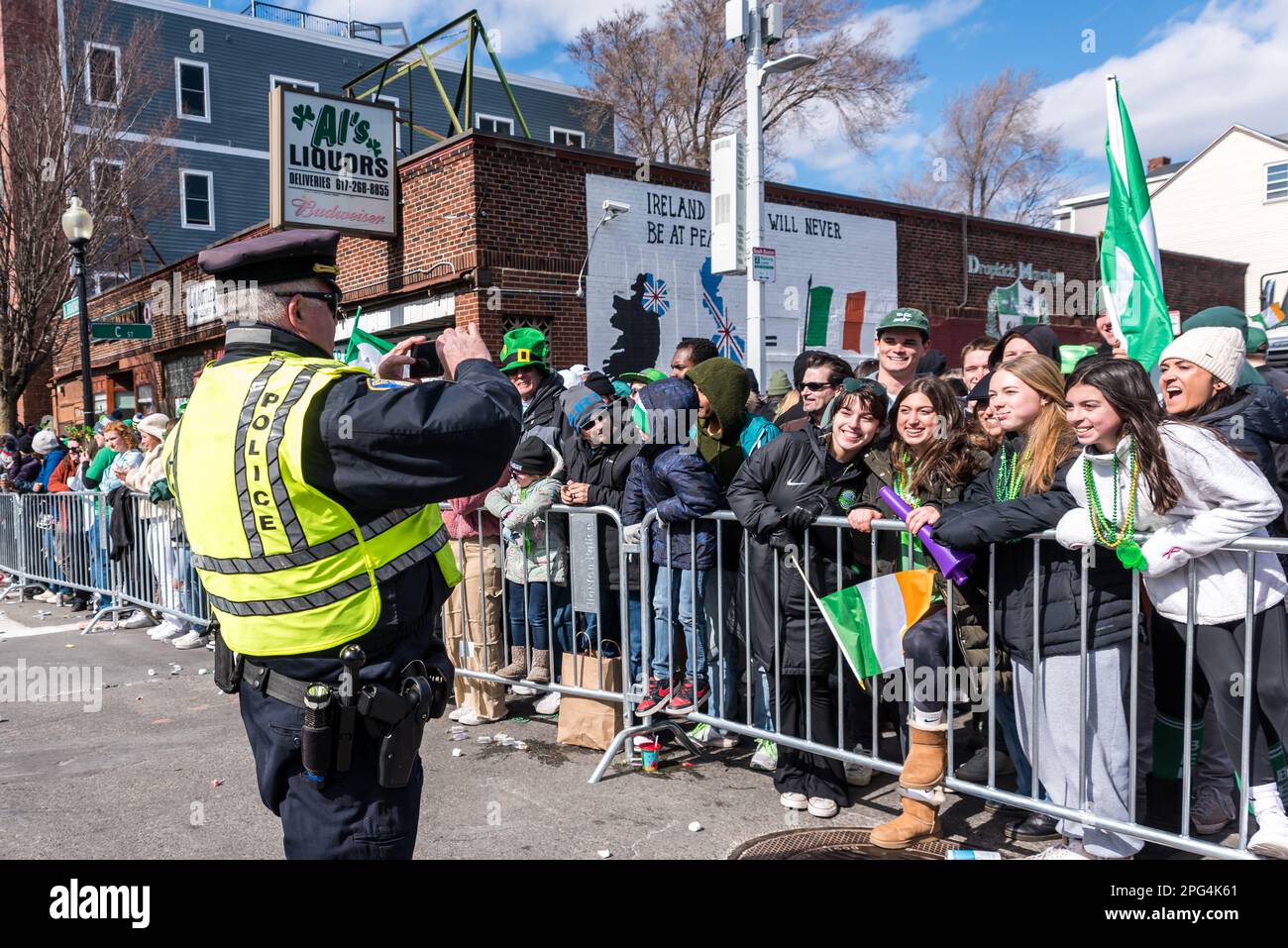 Boston Police officer taking a picture for kids in the crowd at 2023 ...