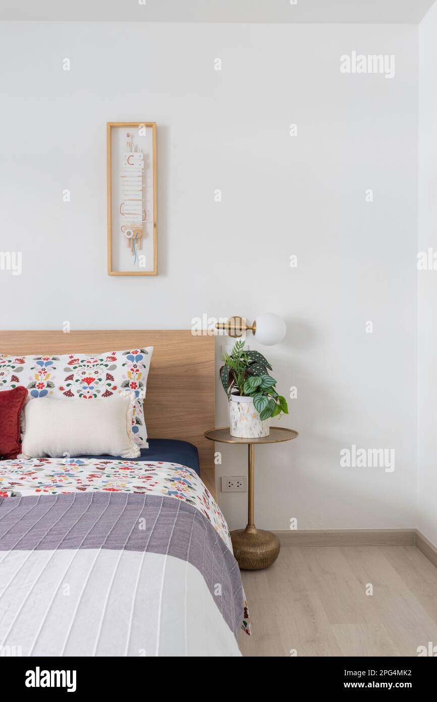 An inviting, modern bedroom with a cozy white bed featuring cheerful ...