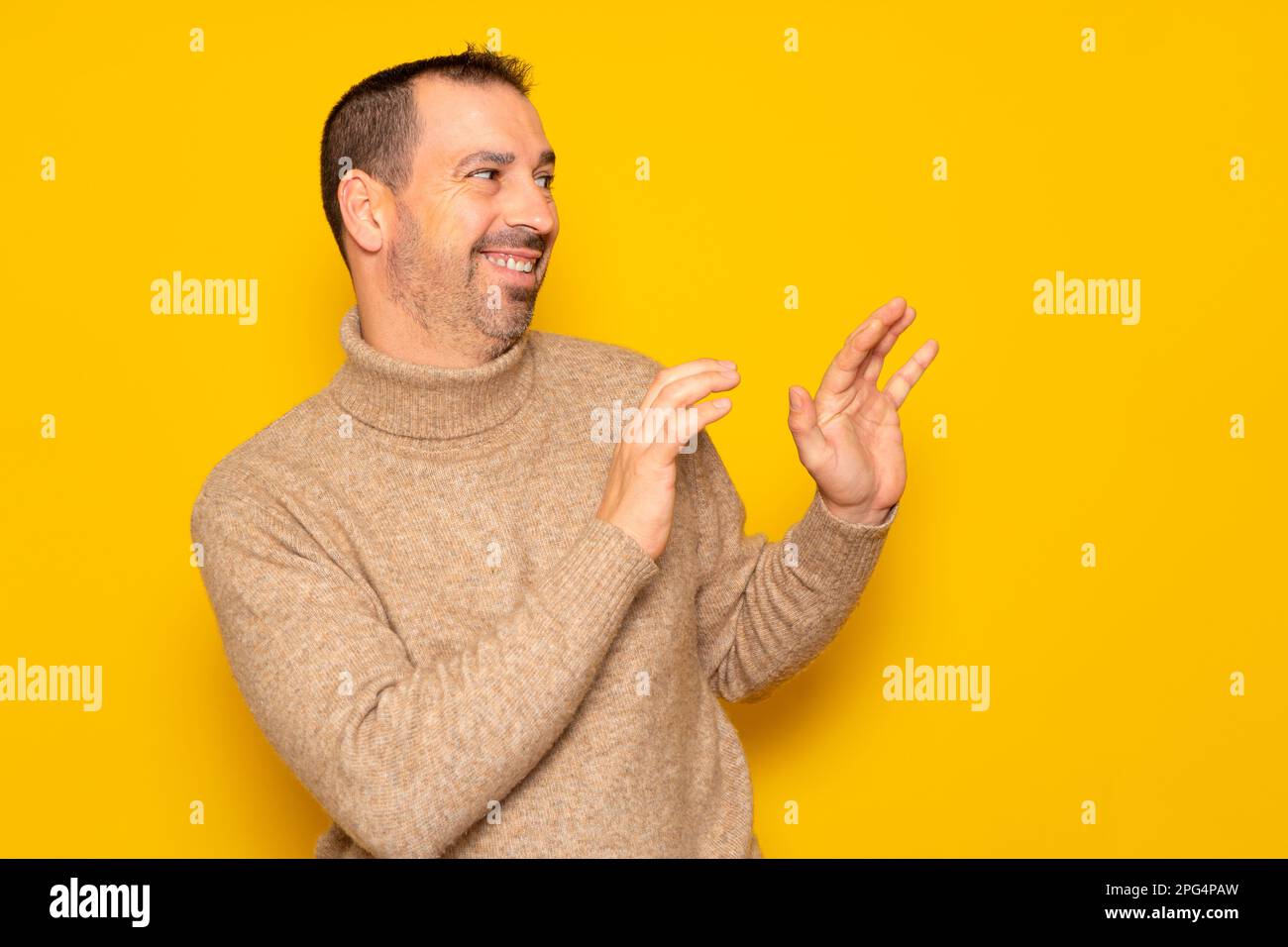Bearded hispanic man in a turtleneck ducking to the side in ...