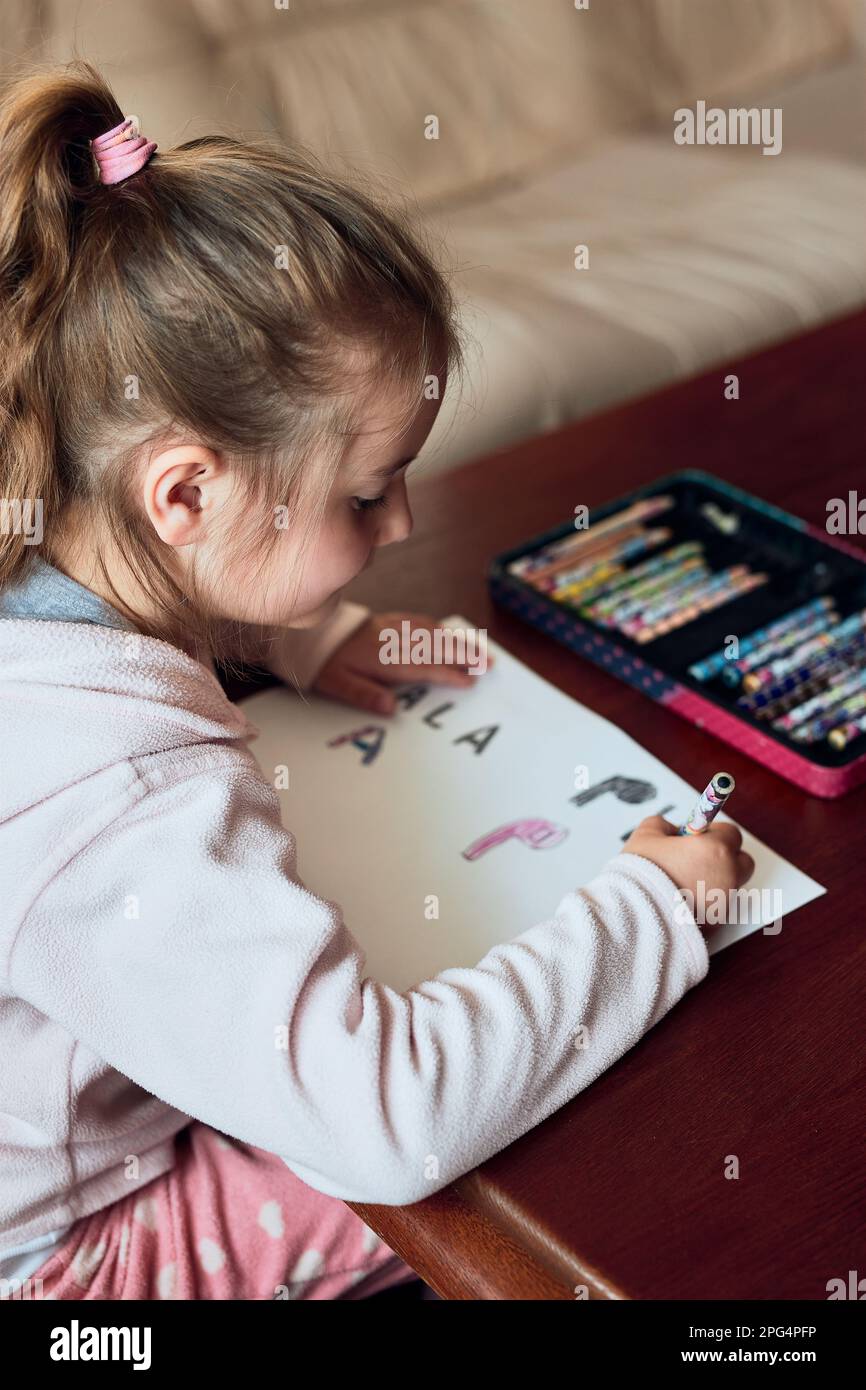 Little girl preschooler learning to write letters at home. Kid using ...