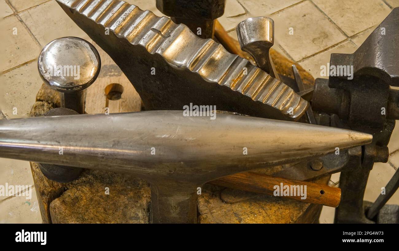 Traditionally worn fine art silversmith tools on an old wooden ...