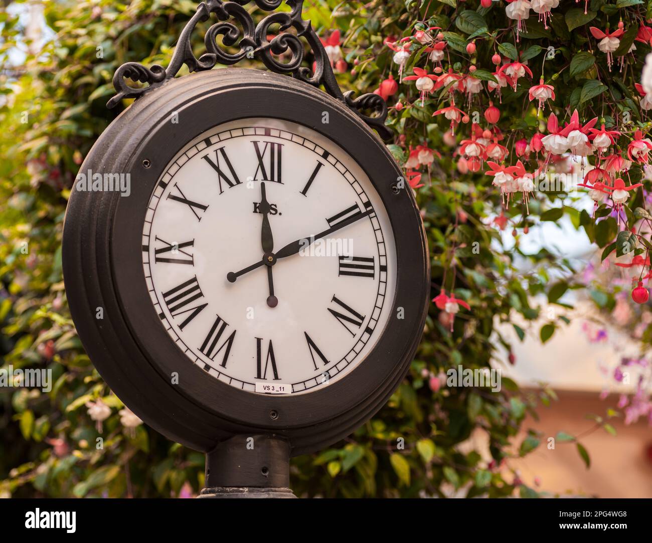 oldfashioned railway station clock pointing ten past noon Stock Photo ...