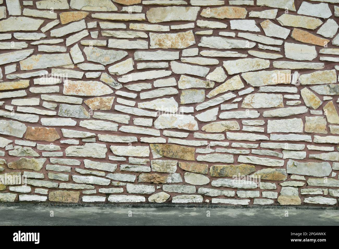 Rock stone wall building siding sidewalk Stock Photo - Alamy
