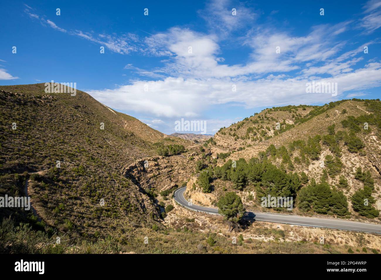 View of Puerto de la Cadena with winding road between arid mountains ...