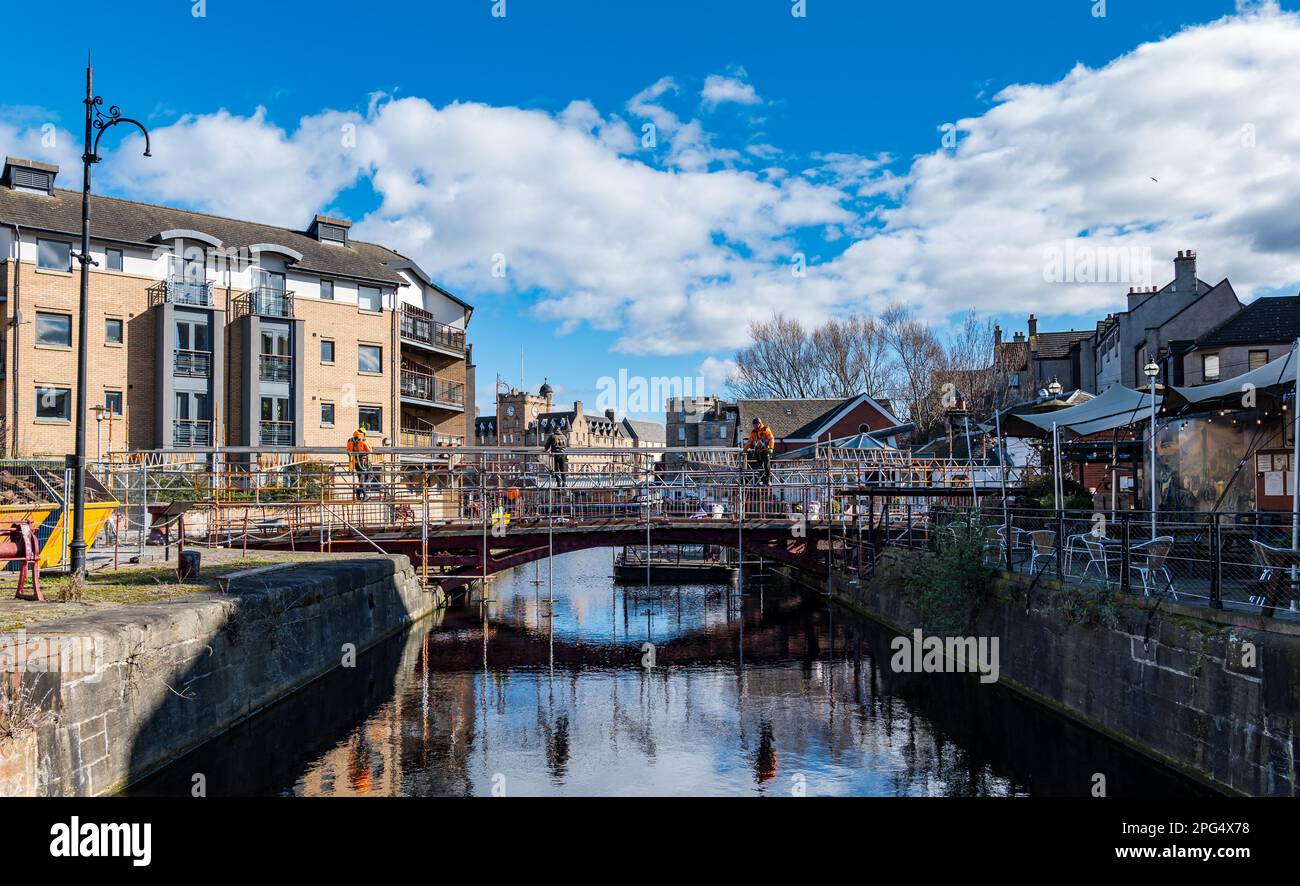 Workmen restoring old swing bridge, Water of Leith, Rennie's Lock ...