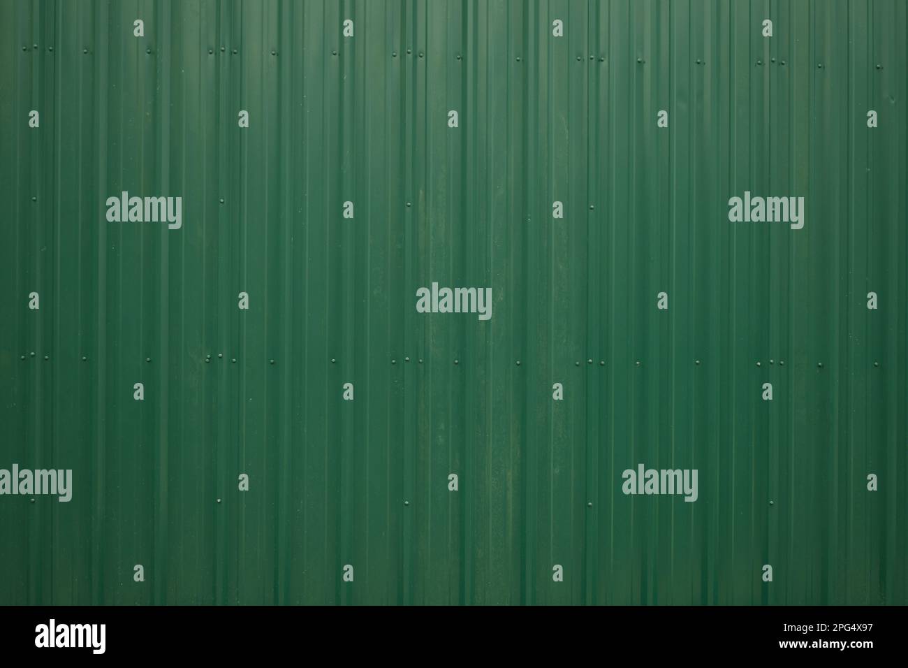 Hunter green metal warehouse siding Stock Photo - Alamy