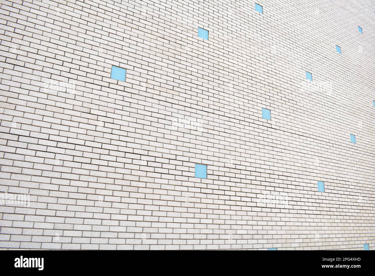 White brick building blue diagonal tiles Stock Photo - Alamy