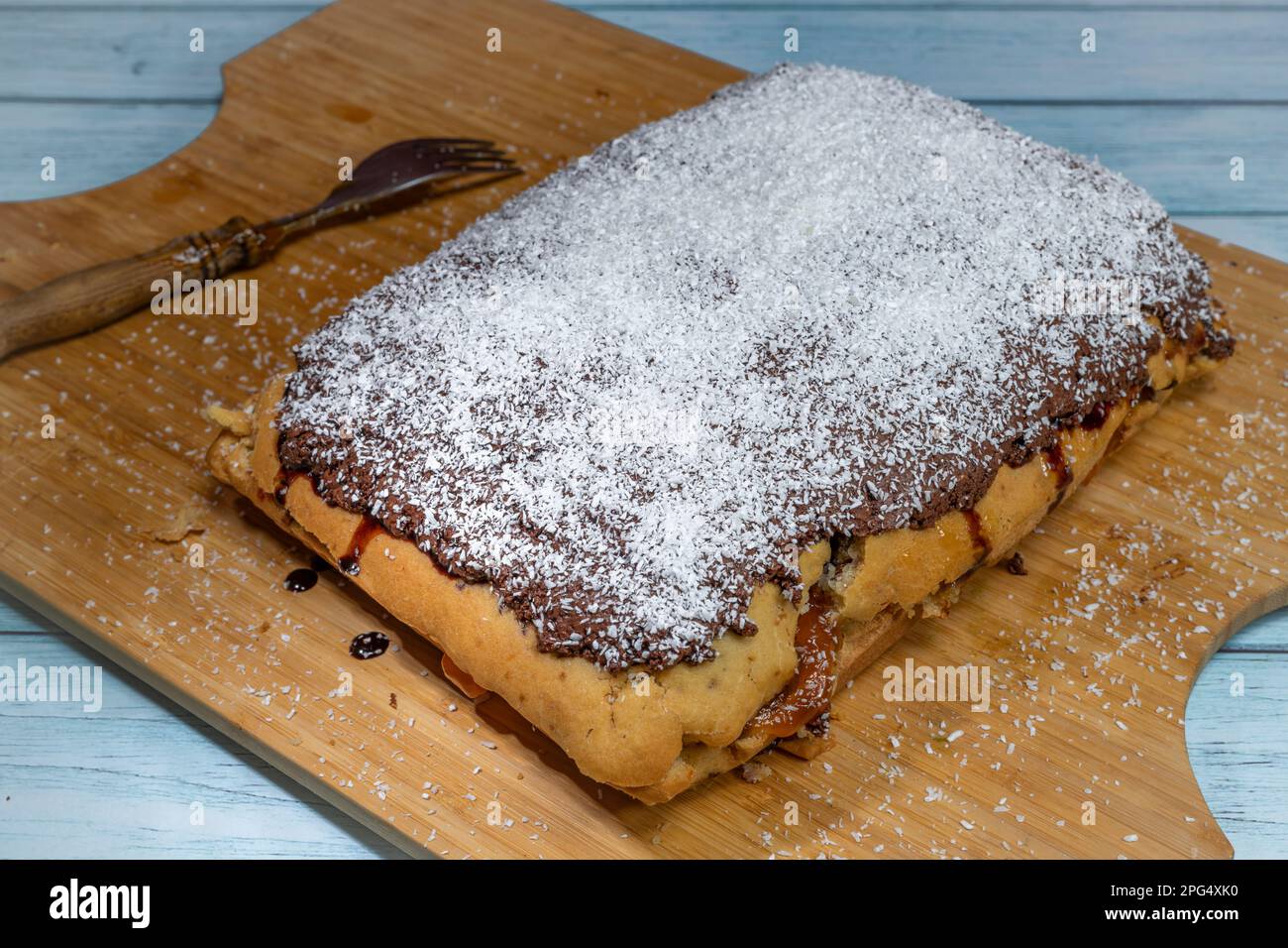 Vegan chocolate apricose cake with dry cranberry on blue dish and dark ...