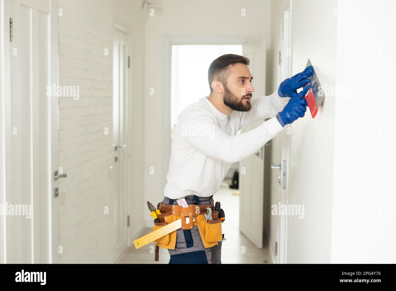 Construction worker are using sponge and plastering trowel to smooth ...
