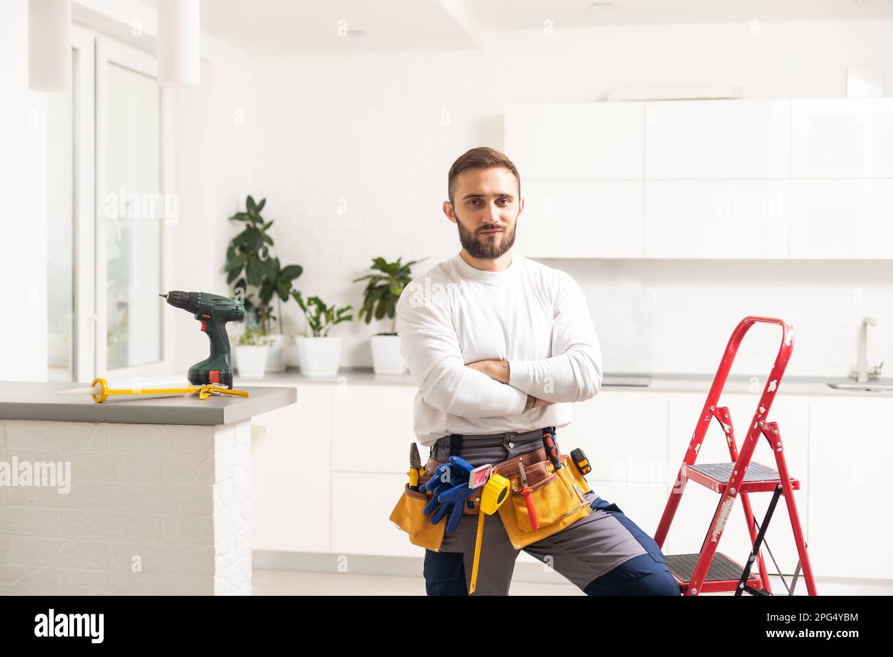 Home repairs. Portrait of professional male repairman with metal ladder ...