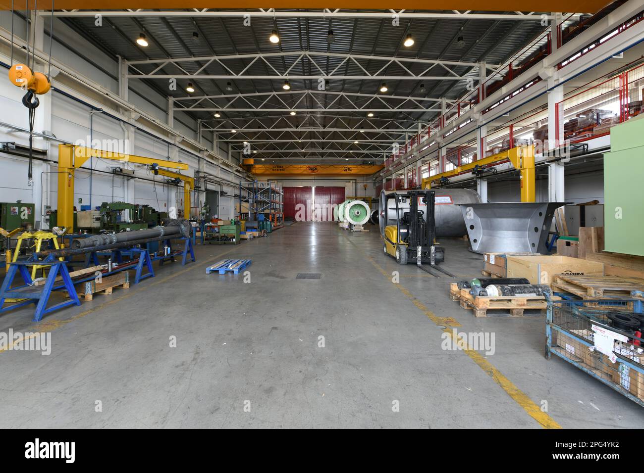 A large industrial warehouse with newly manufactured heavy equipment ...