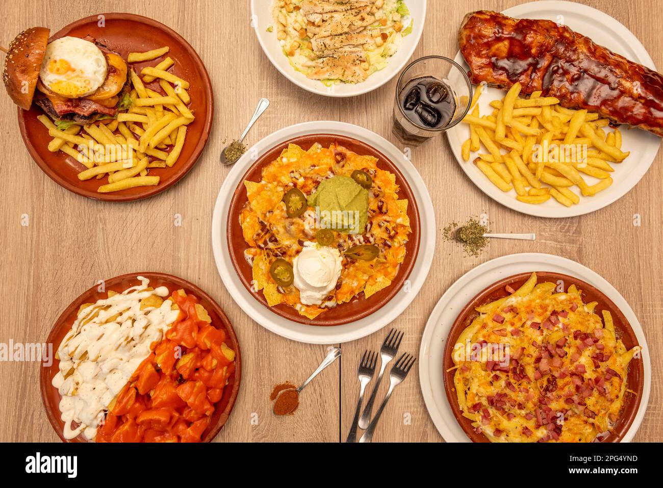 Set of Mexican or tex mex fast food dishes with nachos with guacamole ...