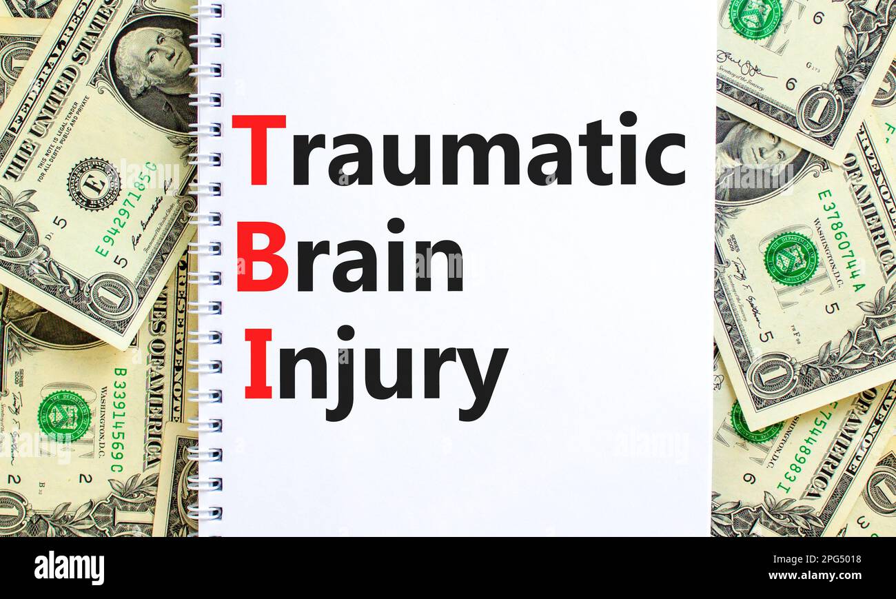 TBI traumatic brain injury symbol. Concept words TBI traumatic brain injury on white note on a ...