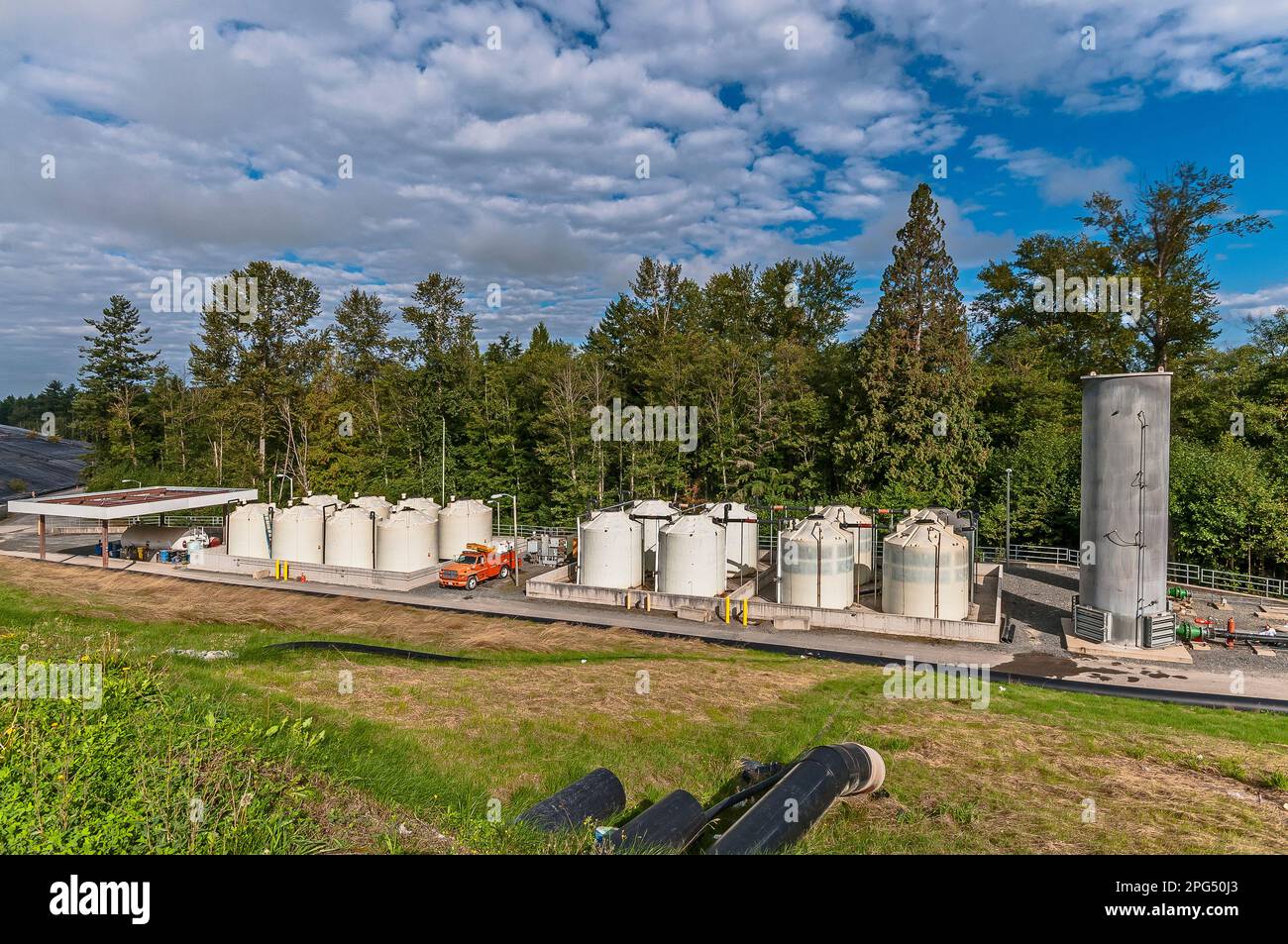 A worker in a storage tank facility in an active landfill Stock Photo ...