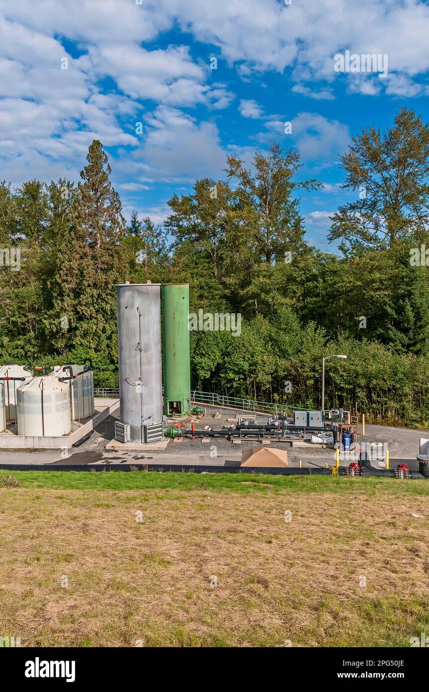 A worker in a storage tank facility in an active landfill Stock Photo ...