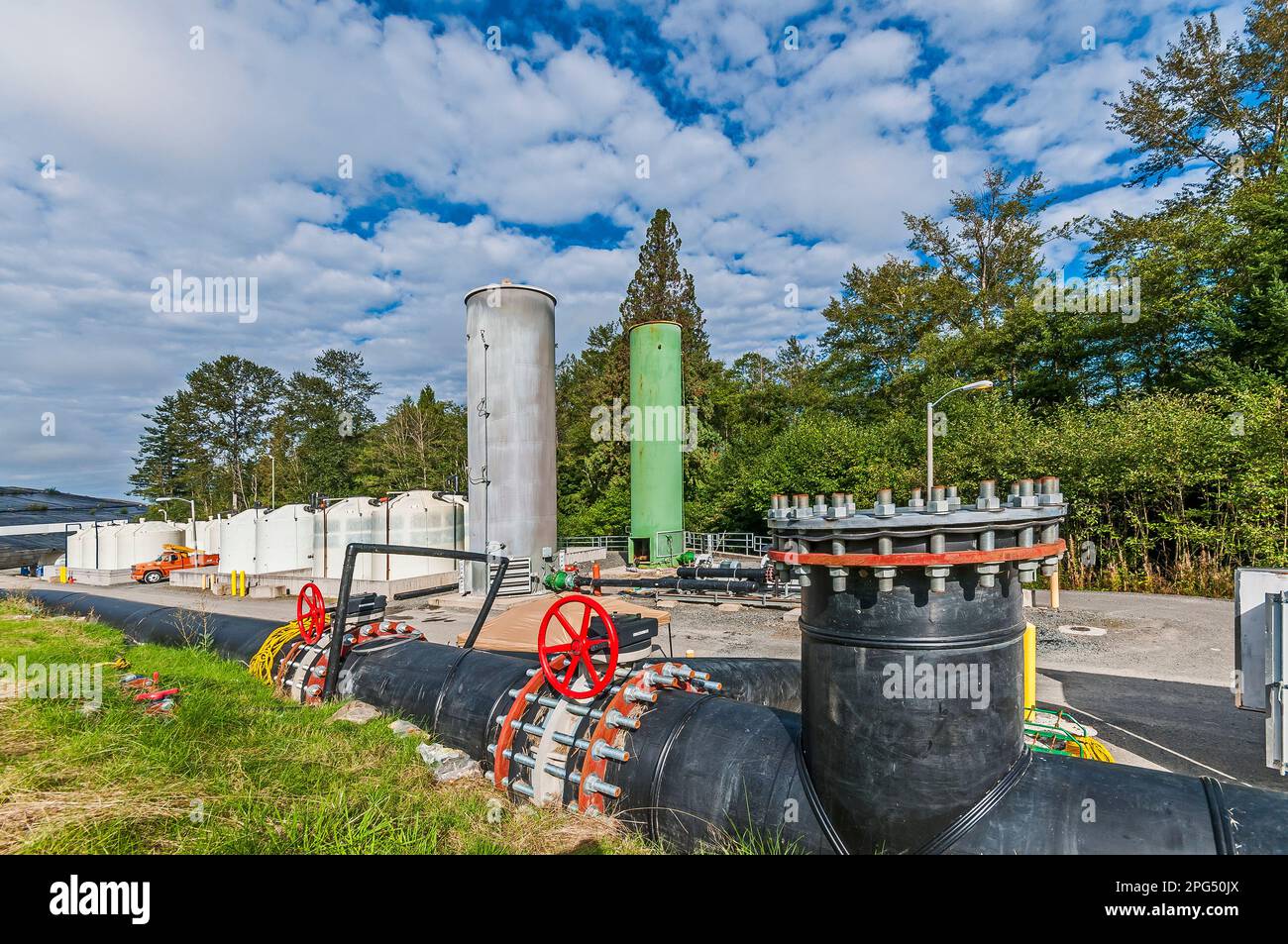 A large pipe with multi-bolt and nut flanges plus valving in the ...