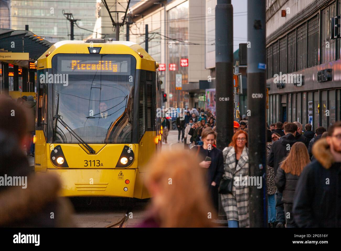 A tram stopped at Market Street in Manchester with huge crowds walking ...