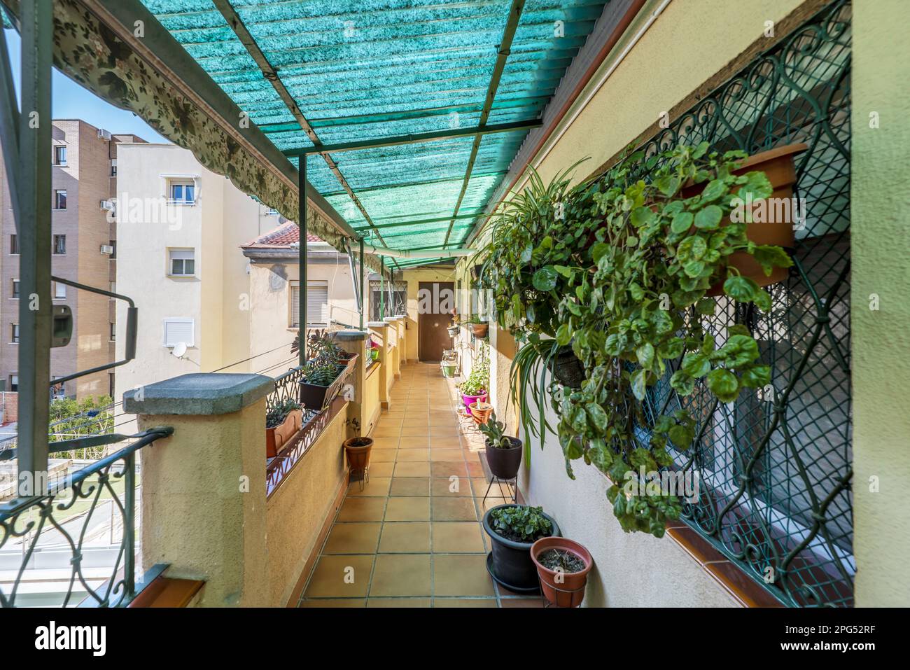A covered corridor in a building with access to multiple houses full of ...