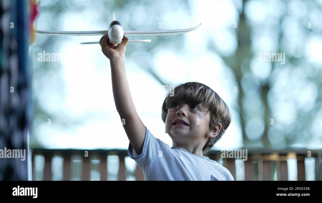 Boy throwing airplane toy hi-res stock photography and images - Alamy