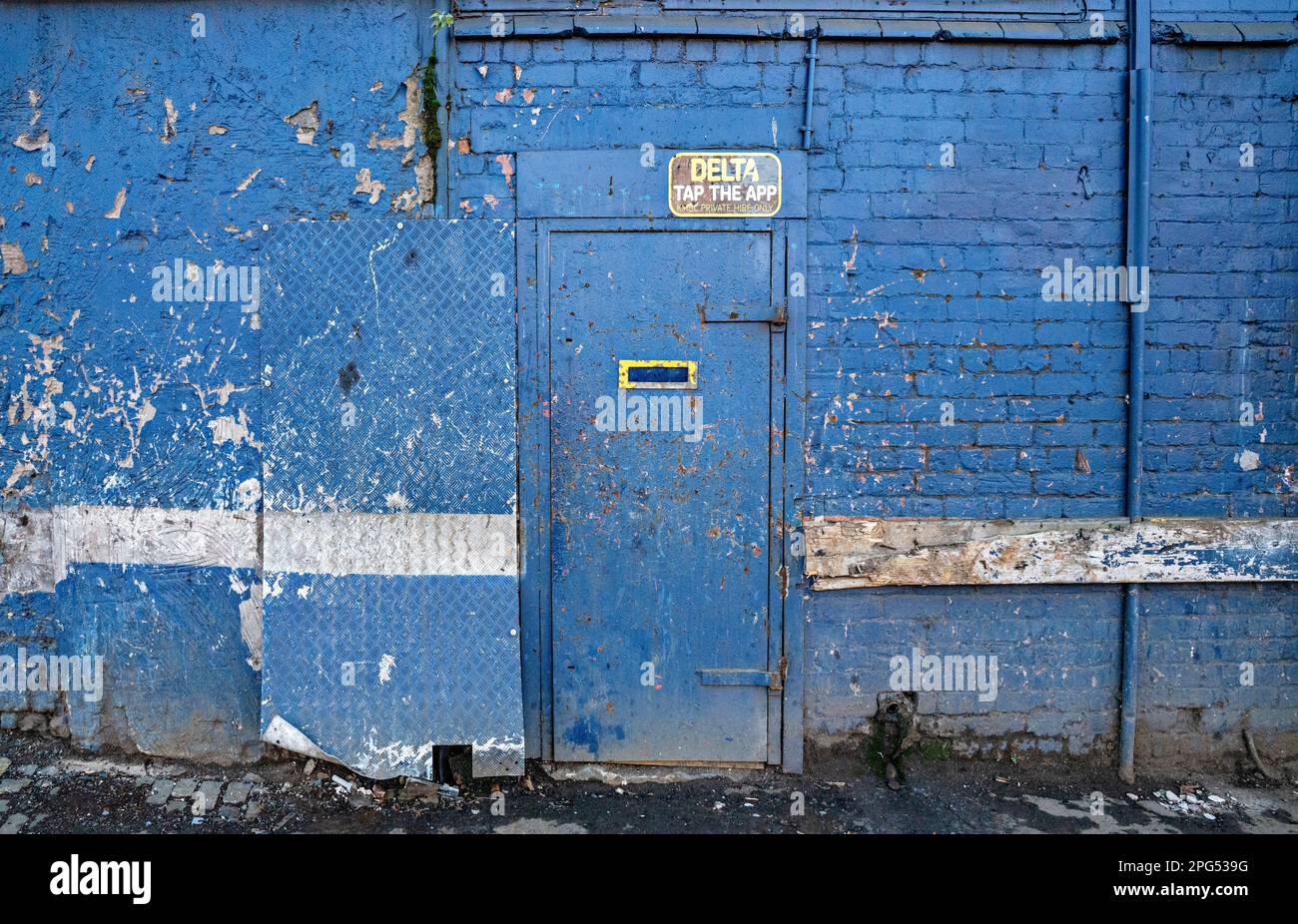 Blue painted facade to Liverpool dockland warehouse Stock Photo - Alamy
