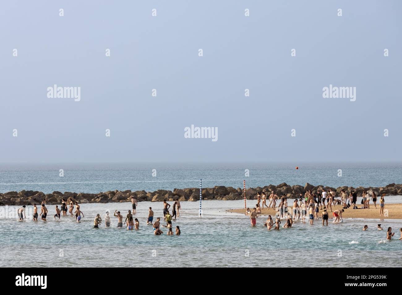 Haifa, Israel 12 March 2023, Young people on Dado Beach sunbathe, play ...