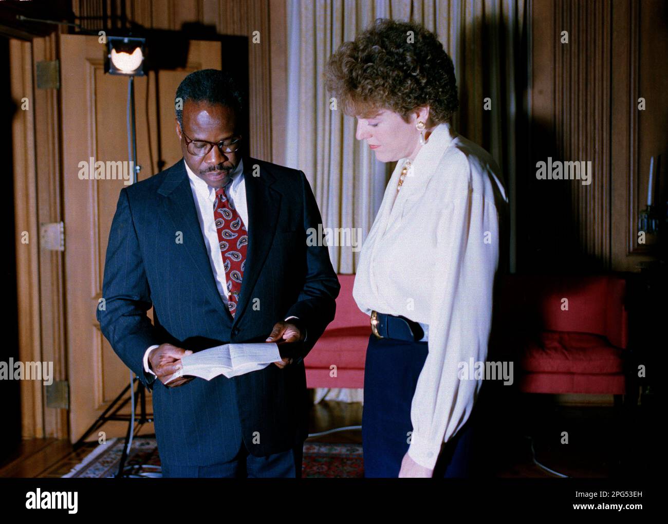Supreme Court Justice Clarence Thomas reads notes as his wife, Virginia ...