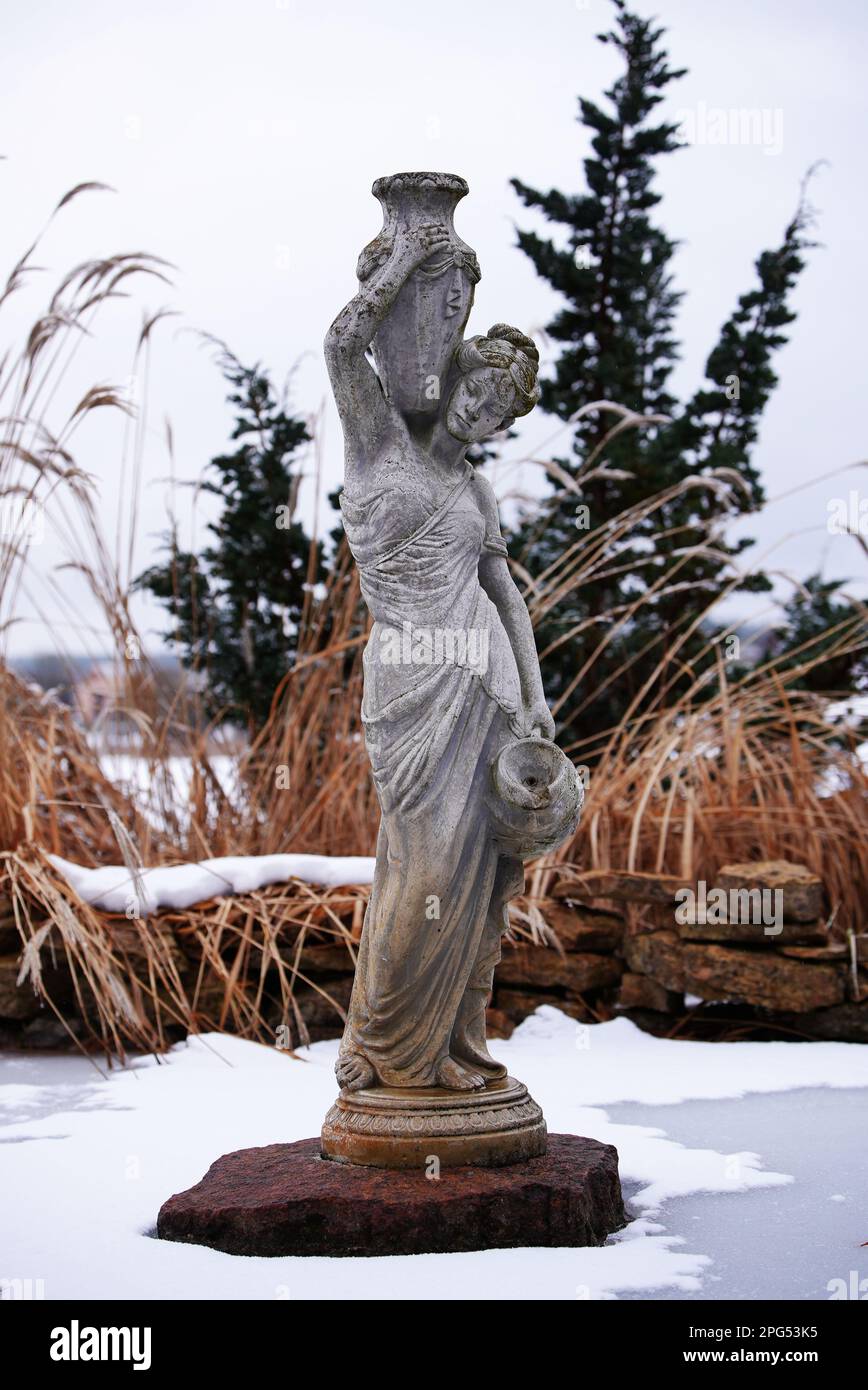 A stunning outdoor winter scene featuring a snow-covered statue set ...