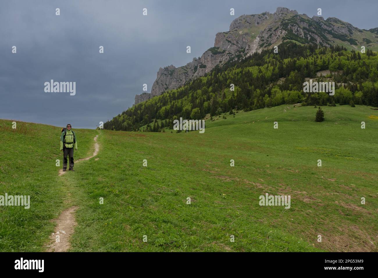 Hiker with backpack, on background Velky Rozsutec, mountain in National ...