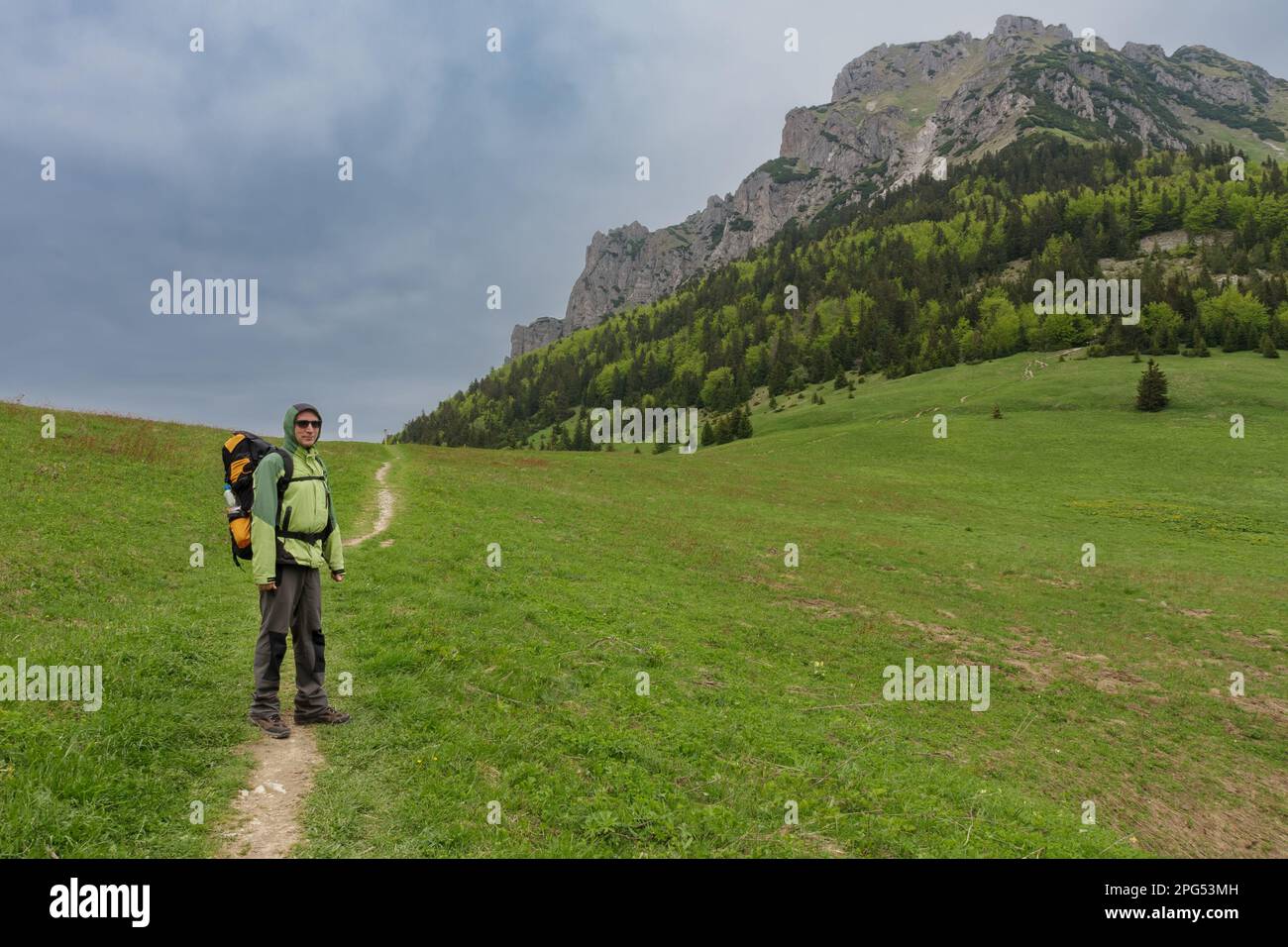 Hiker with backpack, on background Velky Rozsutec, mountain in National ...