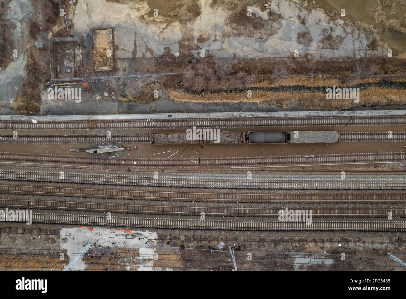 A top down view over an old train yard with old box train cars ...