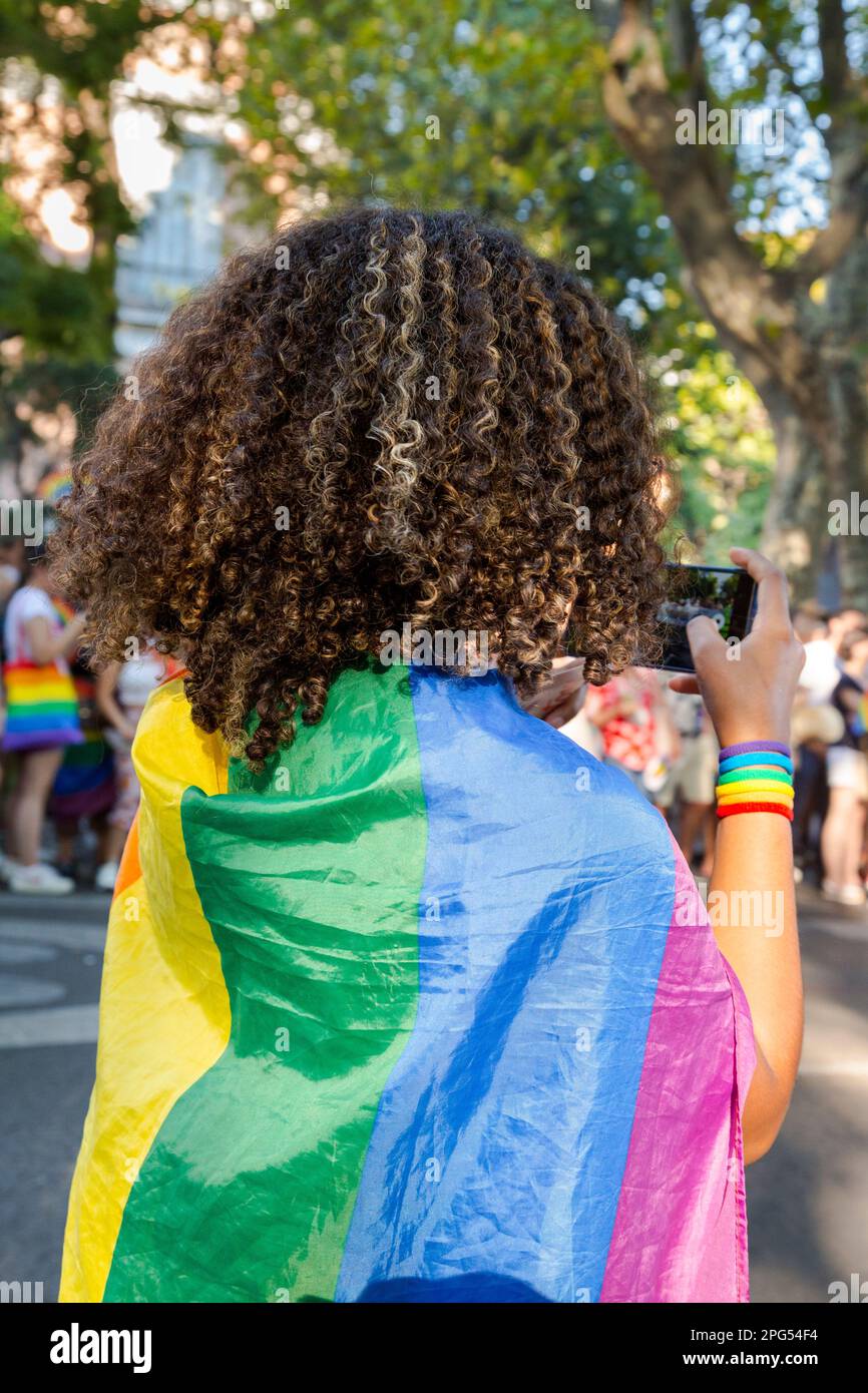 Afro woman with pride flag. Afro girl taking a photo with mobile phone ...