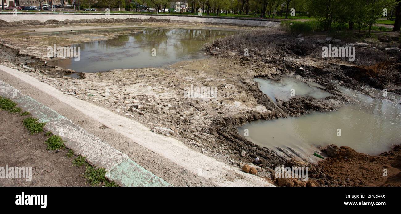 Ecological catastrophy. Drying lake in city park. Dry swamp lake ...
