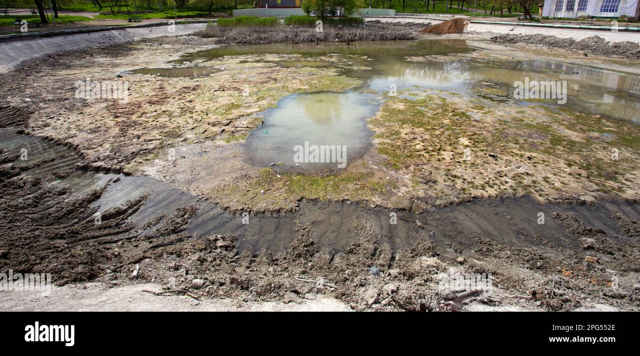 Ecological catastrophy. Drying lake in city park. Dry swamp lake ...