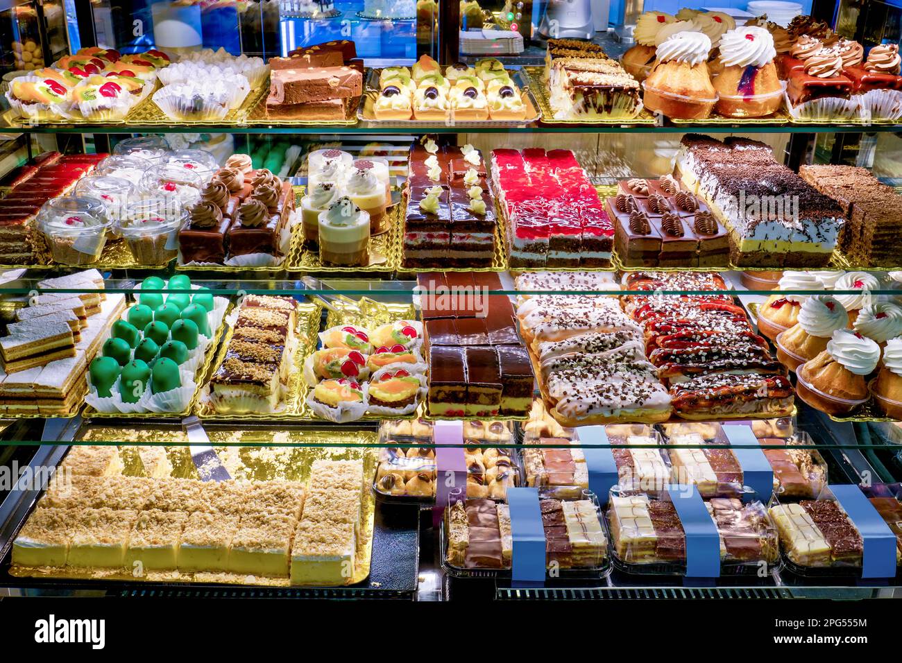 Showcase with four shelves full of various tasty and beautifully ...