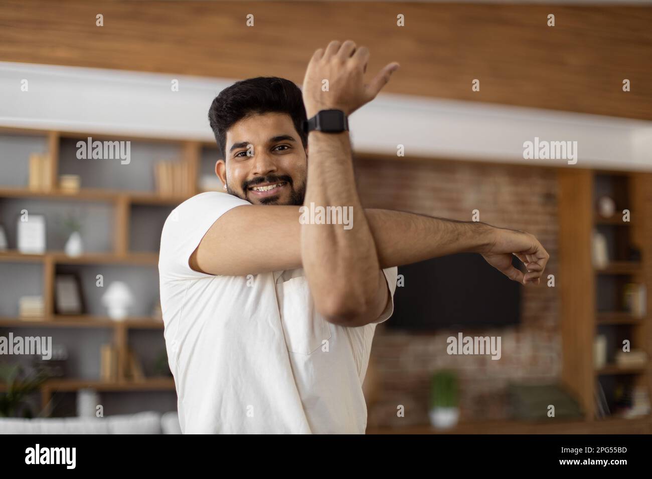 Handsome focused indian man stretching arms for bodybuilder fitness and ...