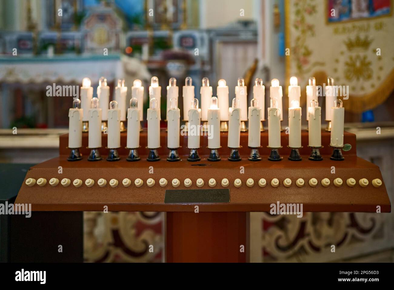Modern electronic candles in the church Stock Photo - Alamy