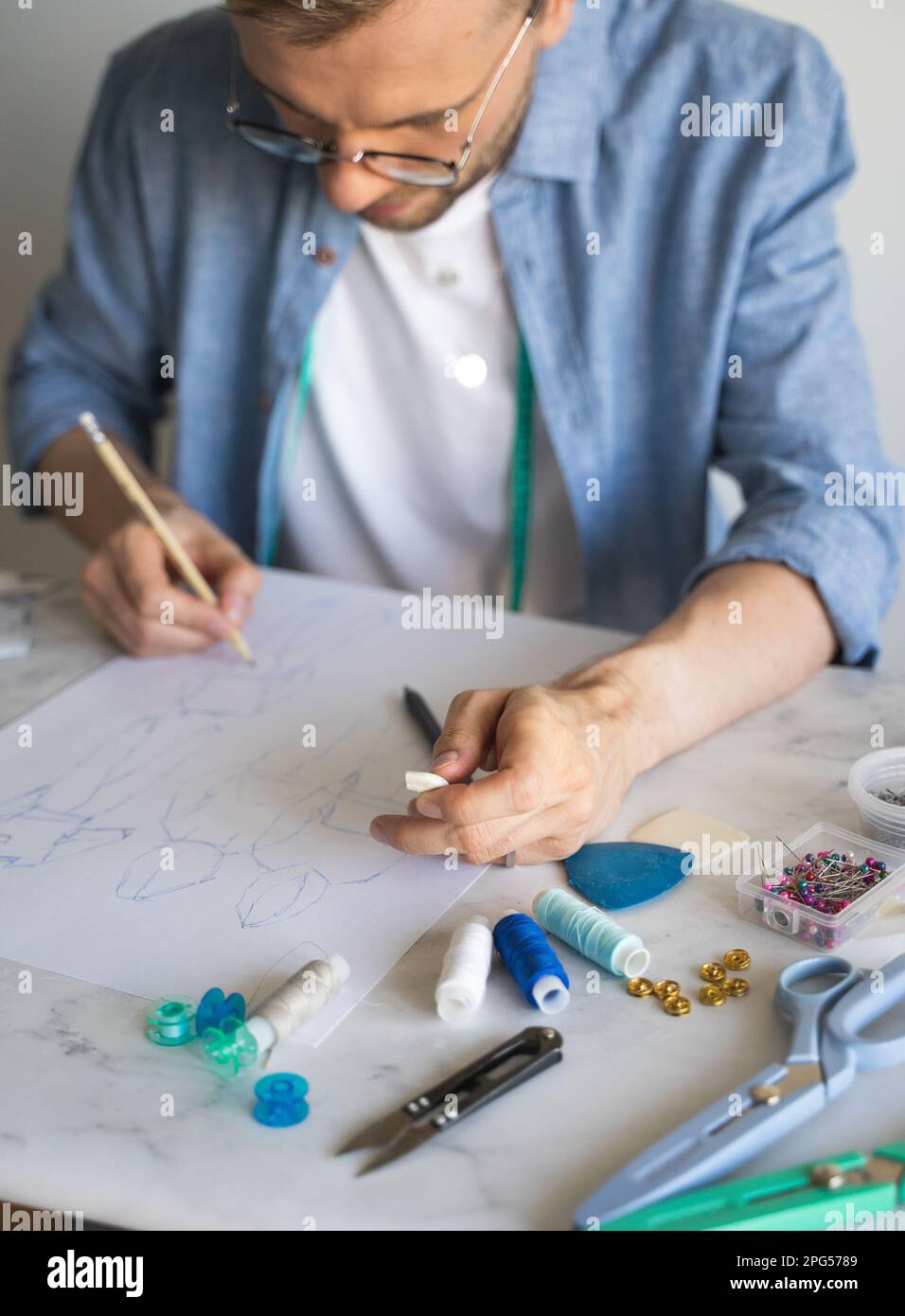 A DIY designer draws a sketch for a new costume project. A seamster ...