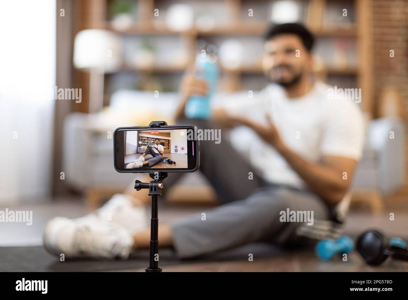 Focus on advanced mobile phone on tripod being used for making online ...