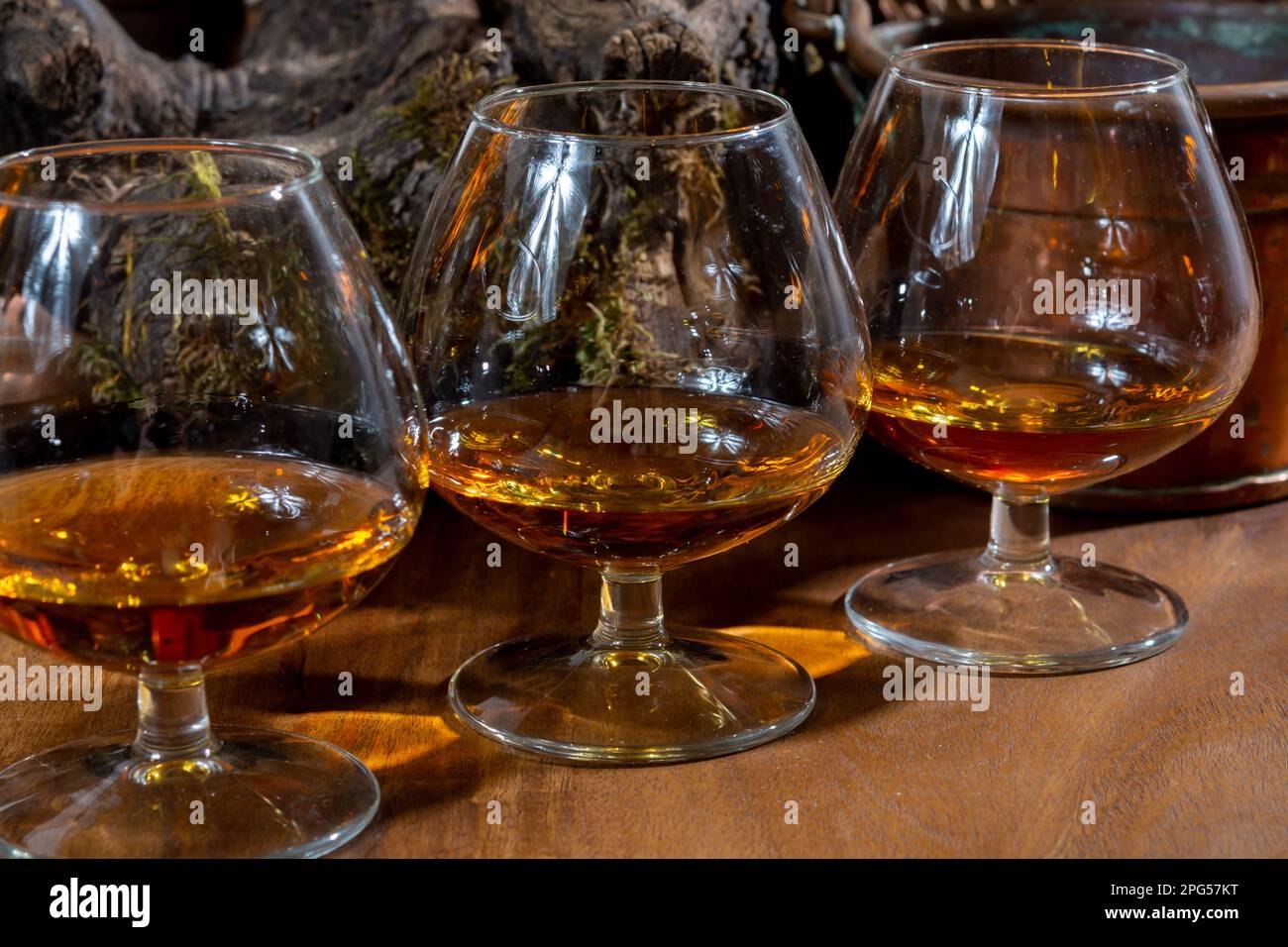 Tasting glasses of aged french cognac brandy alcoholic drink in old ...