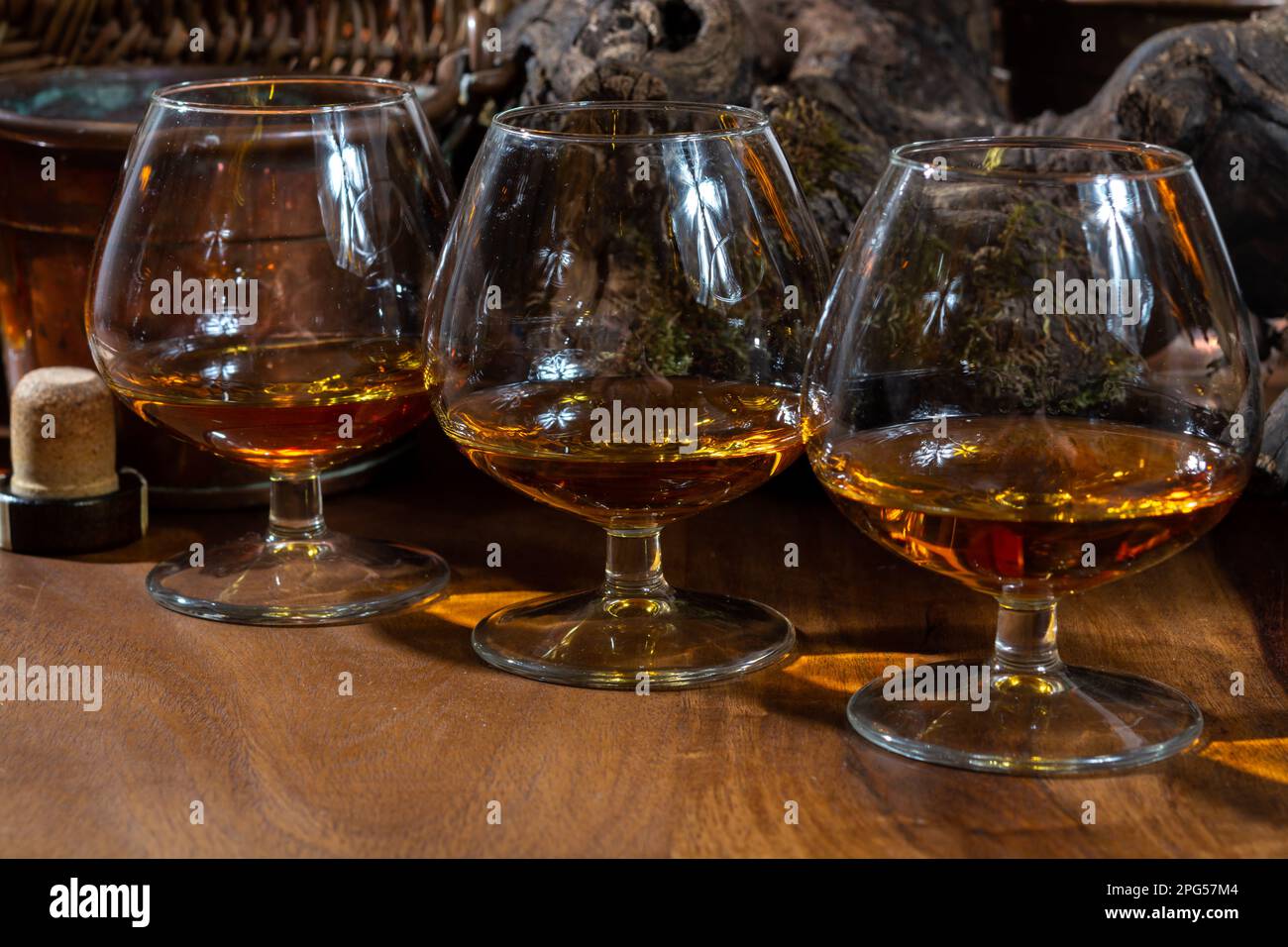 Tasting glasses of aged french cognac brandy alcoholic drink in old ...