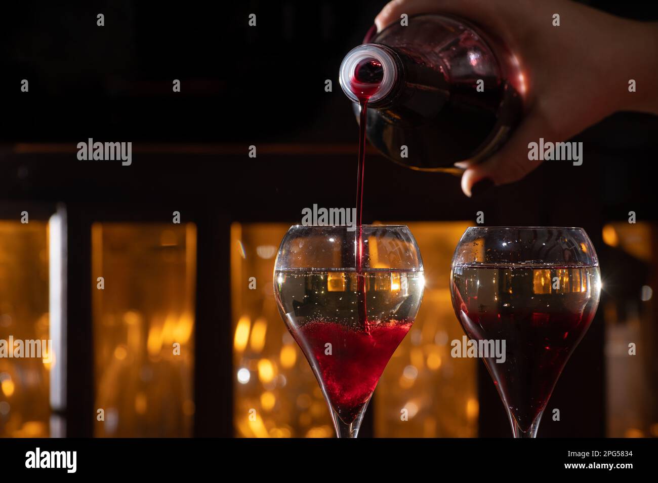 Drinking of Kir Royal, French aperitif cocktail made from creme de ...